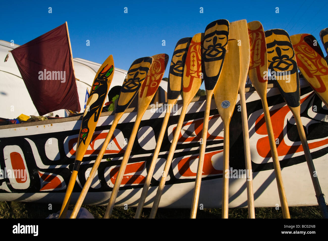 Paddles lie against a war canoe at the Lummi Indian Reservation ...