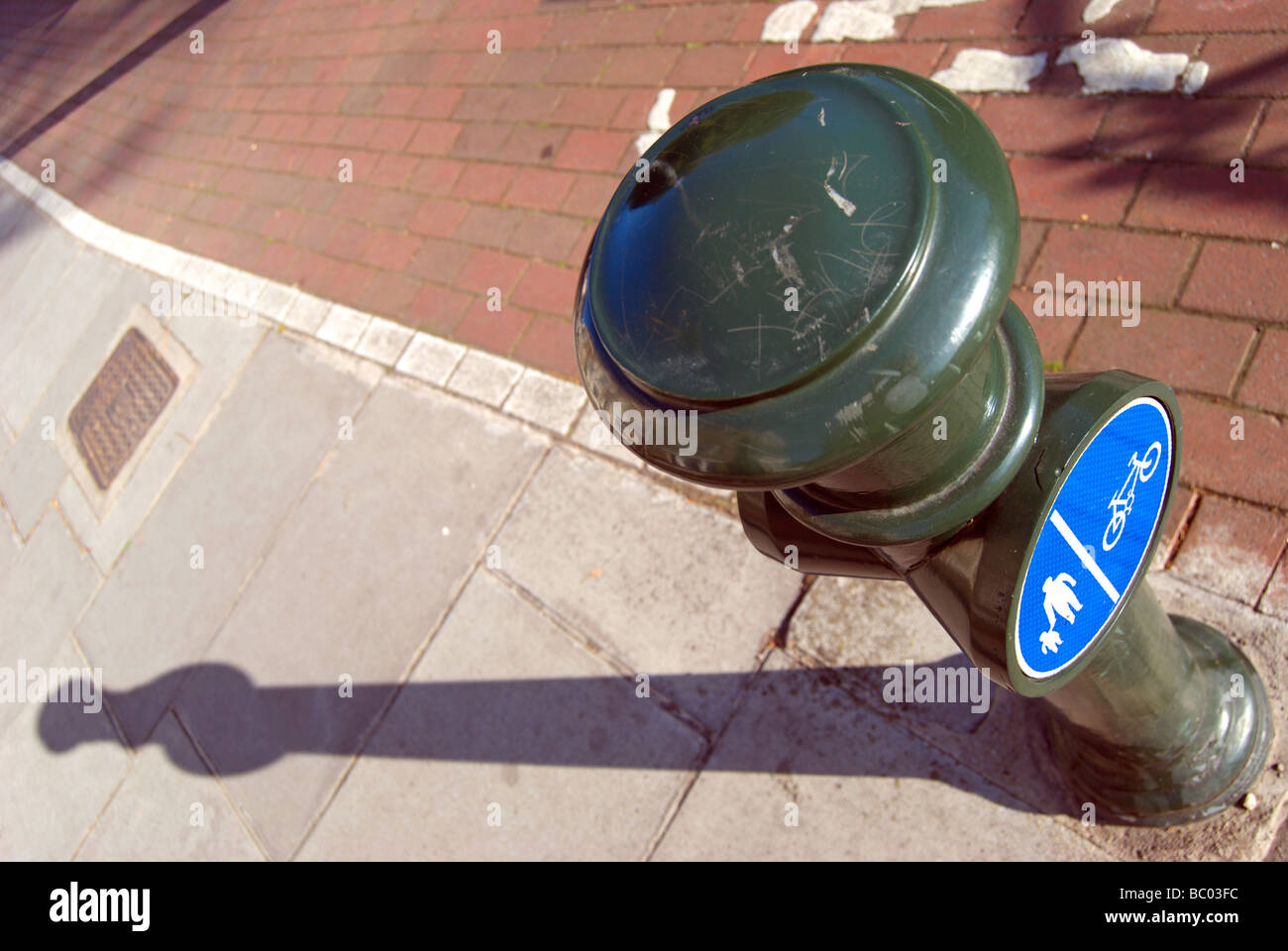 british street bollard with blue and white sign indicating separate ...