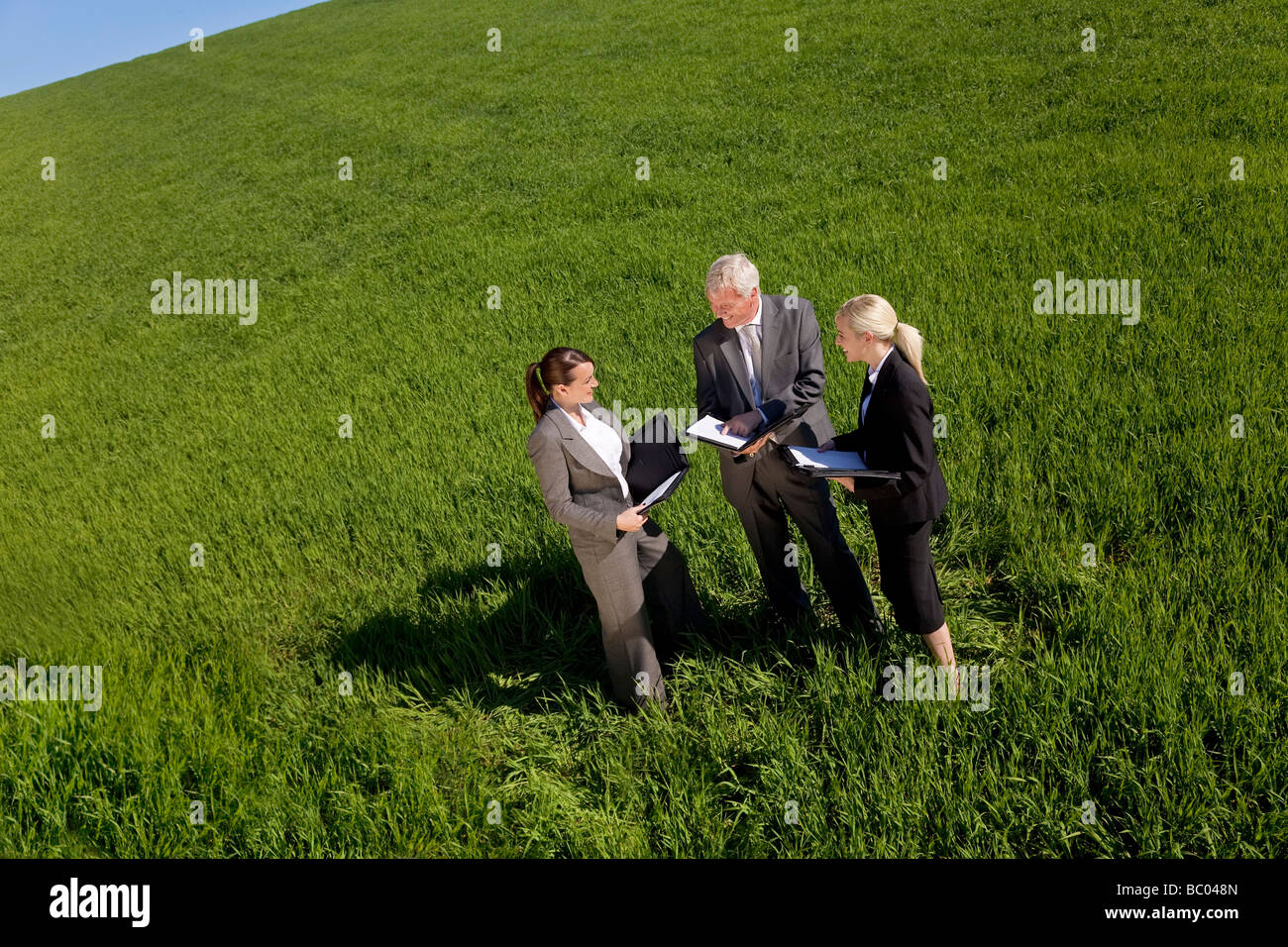 High angle concept shot of a team of three people one man and two women ...
