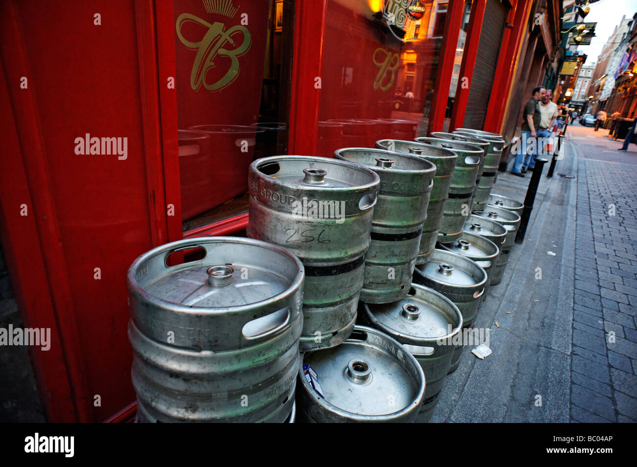 Rows of empty Guinness barrels stacked up in an alleyway outside a pub ...