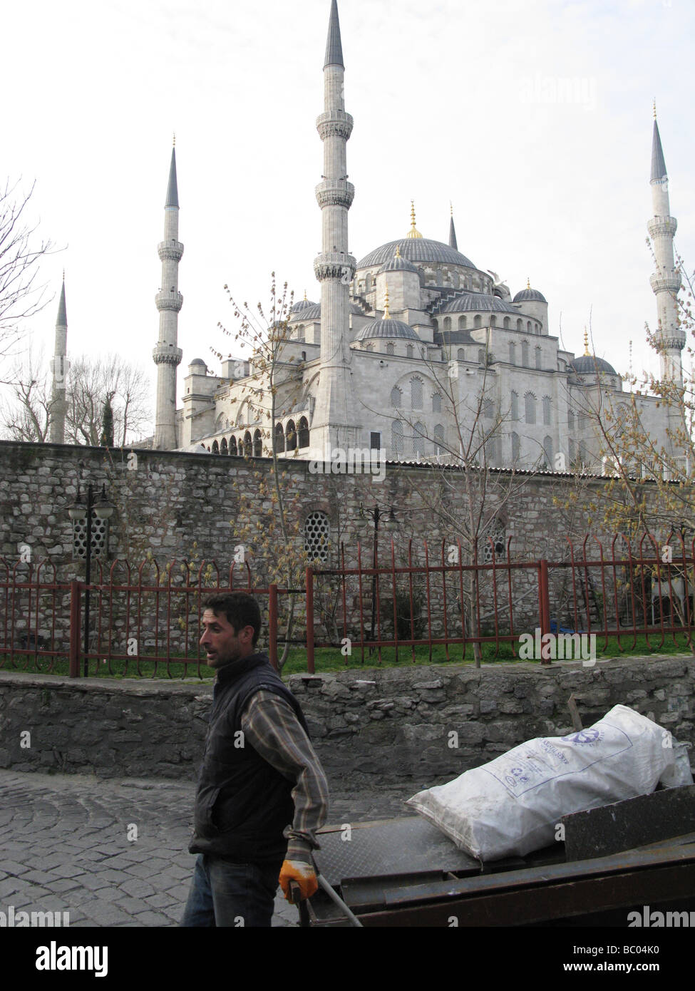 Man pulling a cart with sack of charcoal. The Blue Mosque in the ...