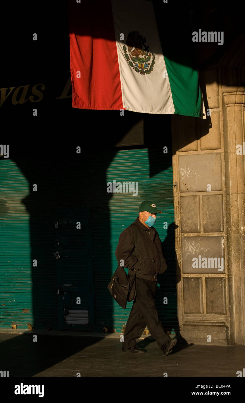 A man wears a mask as a precaution against swine flu in the Zocalo ...