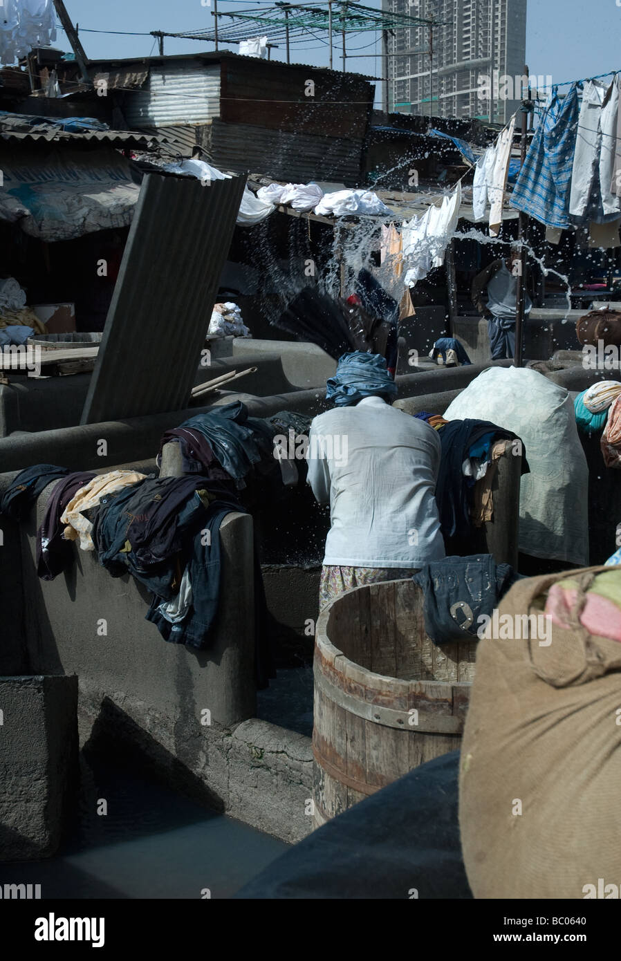 a laundry worker hard at work in the heat of the Mumbai laundry Dhobi ...