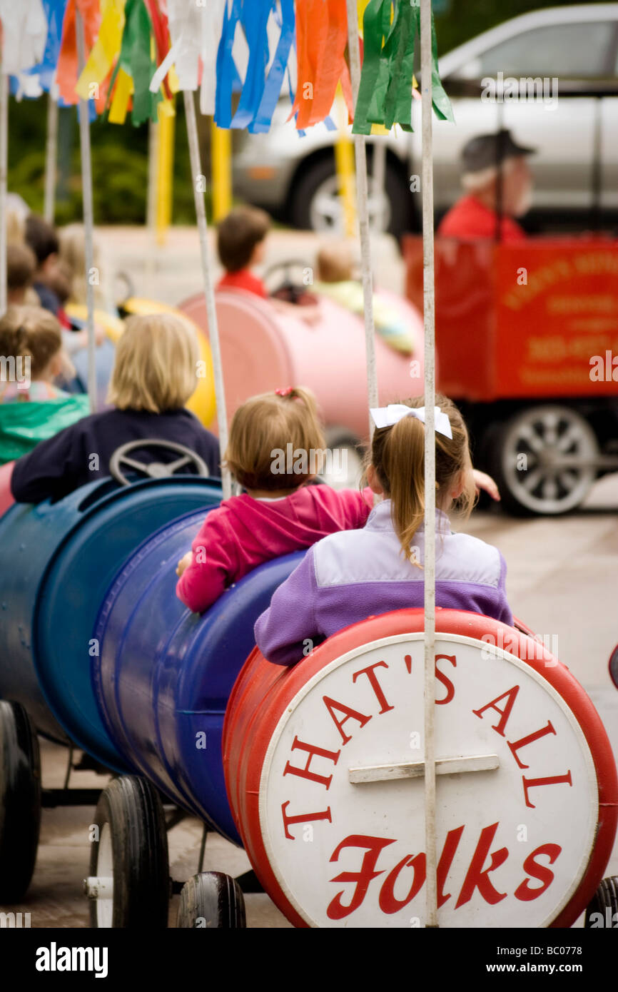 Kids in theme park train ride. Great for themes of family, summer ...