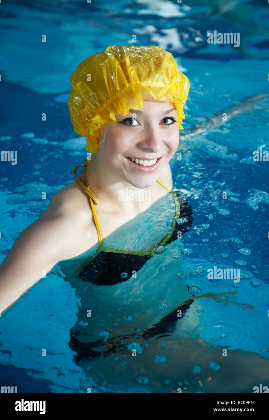 Beautiful woman floating in a swimming pool Stock Photo - Alamy