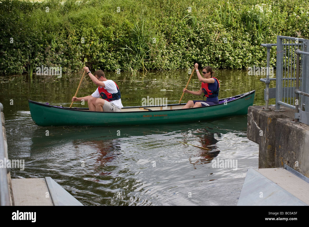 canadian canoeists fish pass canoeing canoe river medway kent england ...