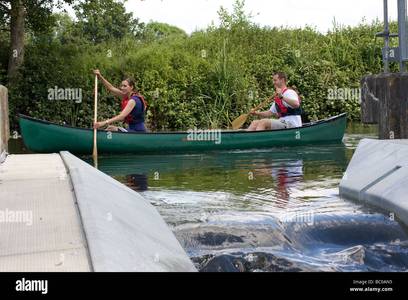 canadian canoeists fish pass canoeing canoe river medway kent england ...