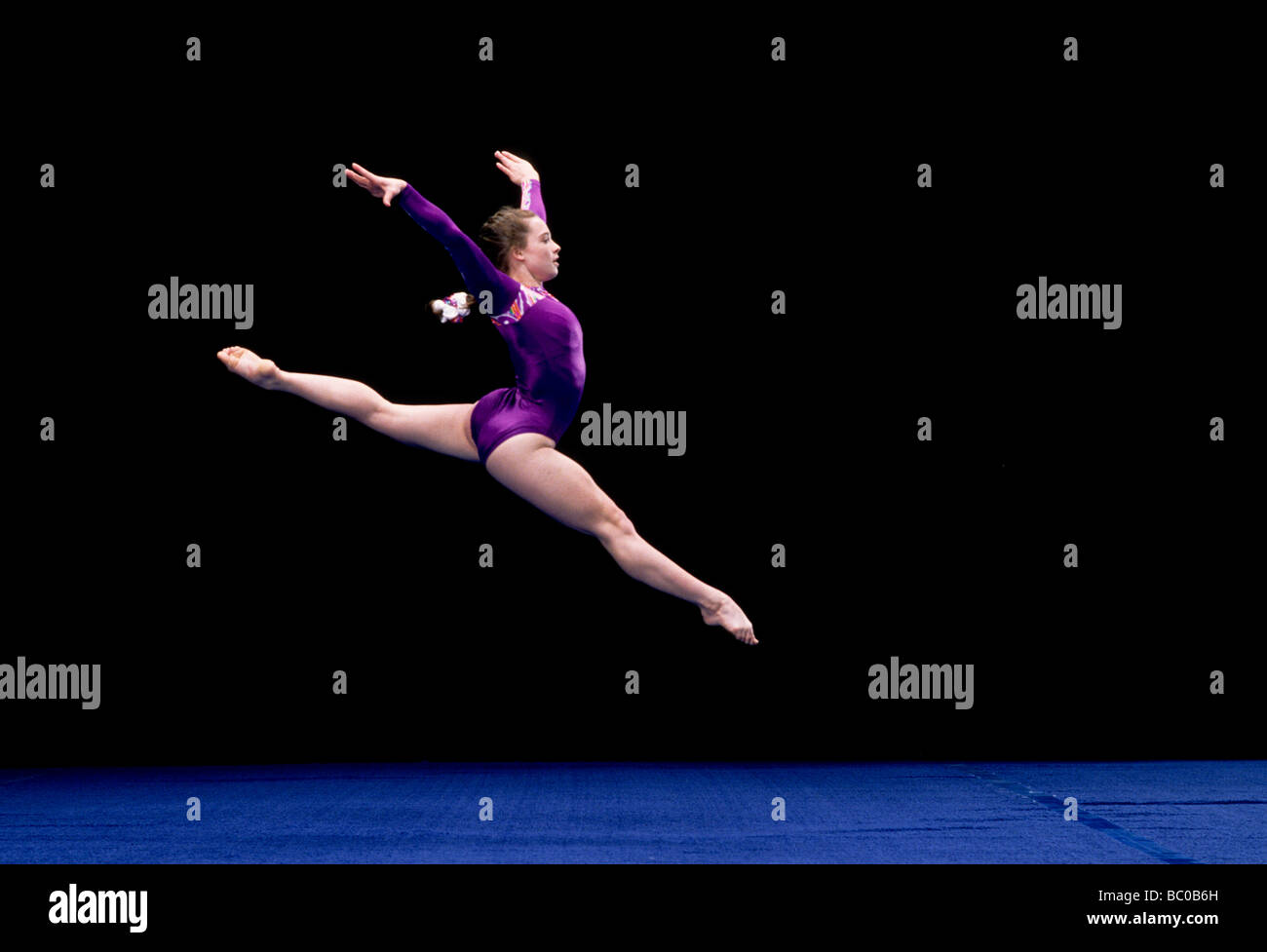 Female gymnast performing on the floor exercise Stock Photo - Alamy
