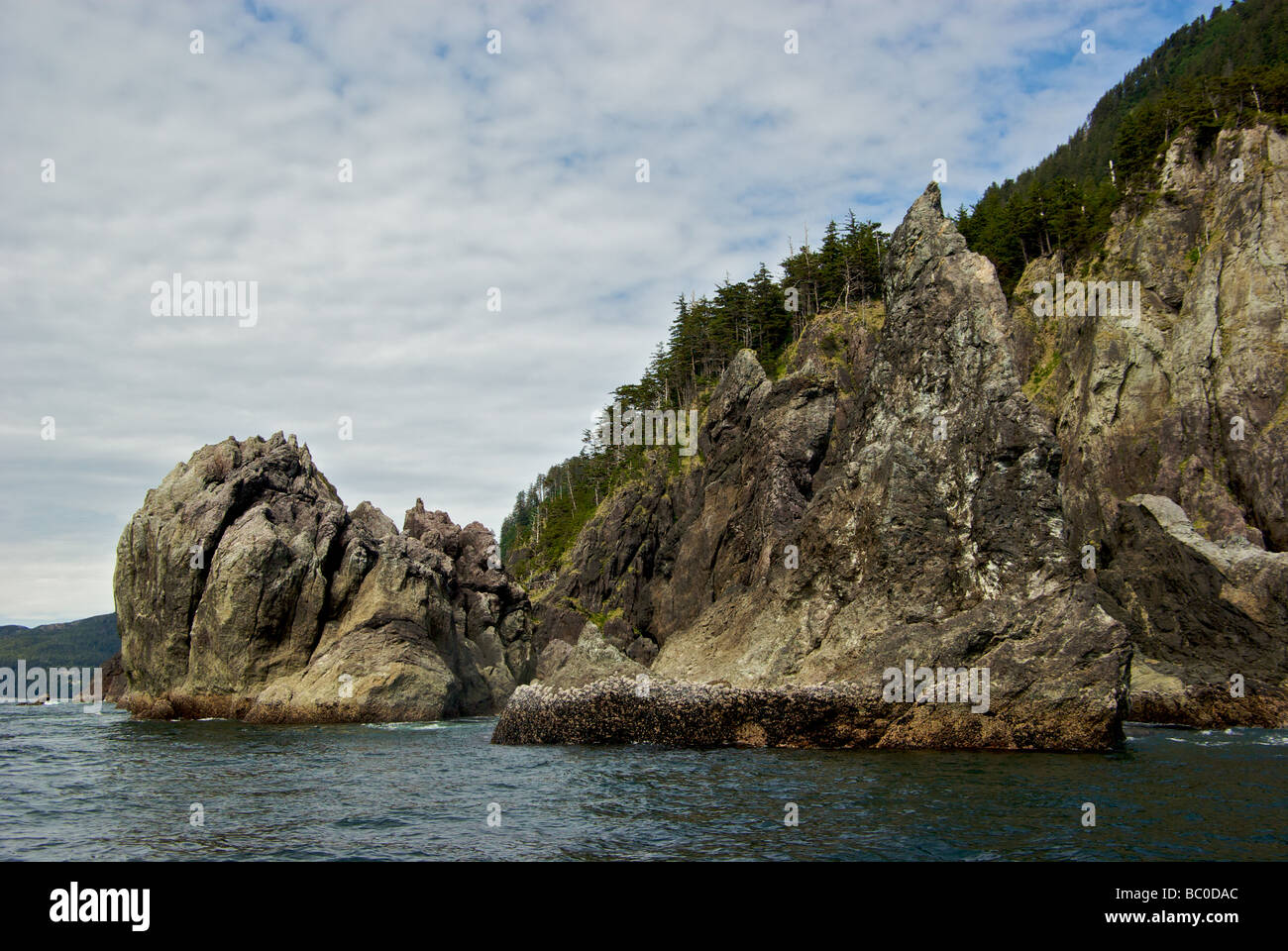 Rugged spire eroded rock formations rise from sea at Skelu Point on ...