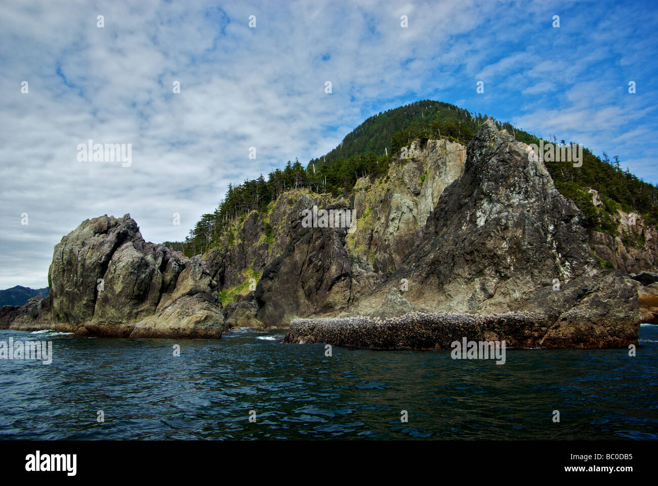 Rugged spire eroded rock formations rise from sea at Skelu Point on ...
