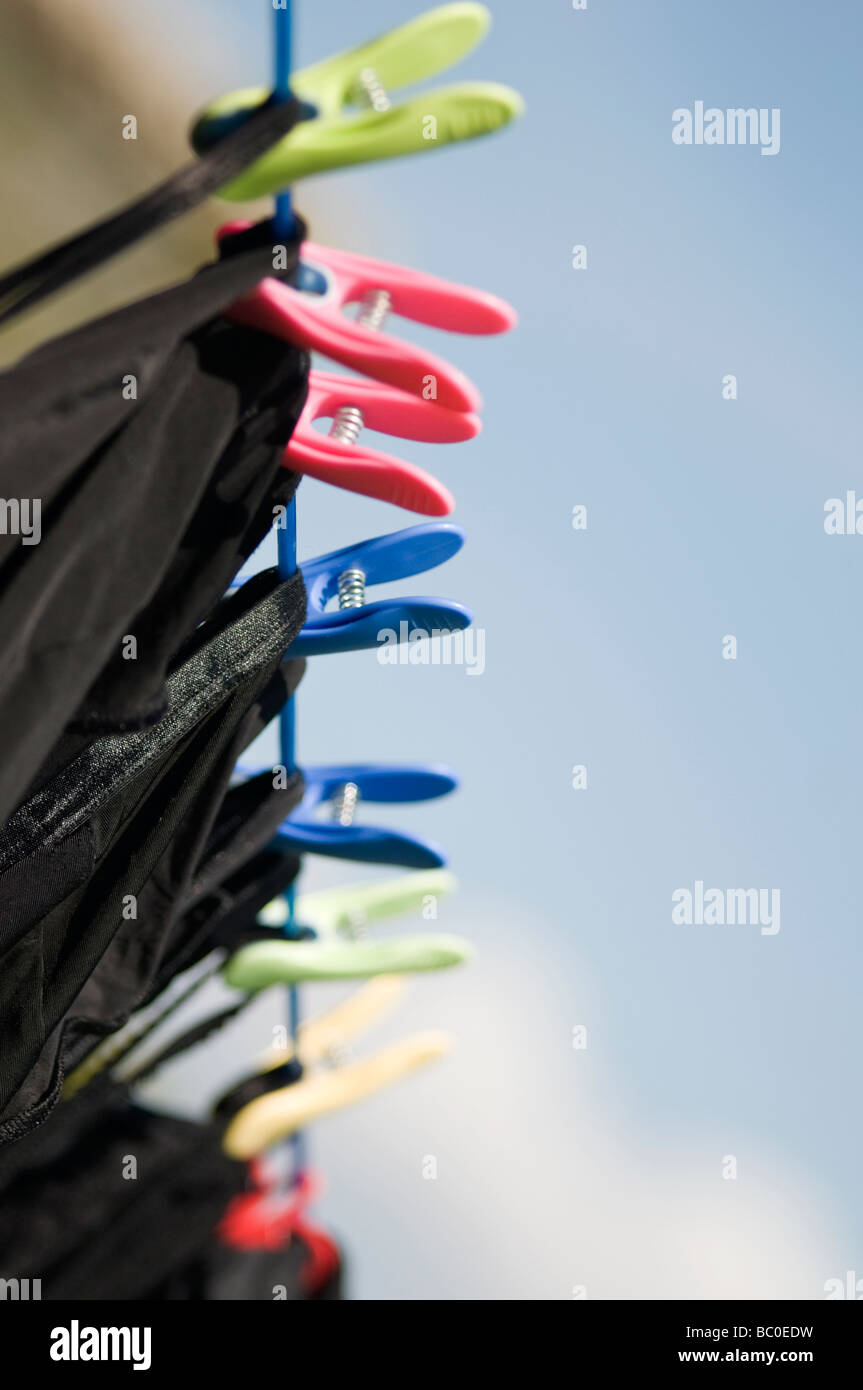 Washing hanging on a line with colourful pegs Stock Photo - Alamy