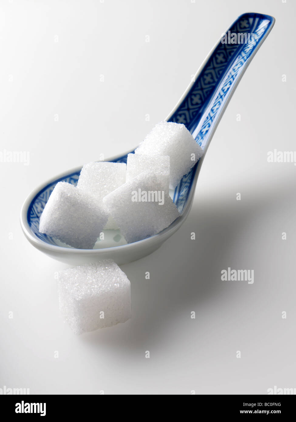 A spoon of sugar lumps Stock Photo - Alamy