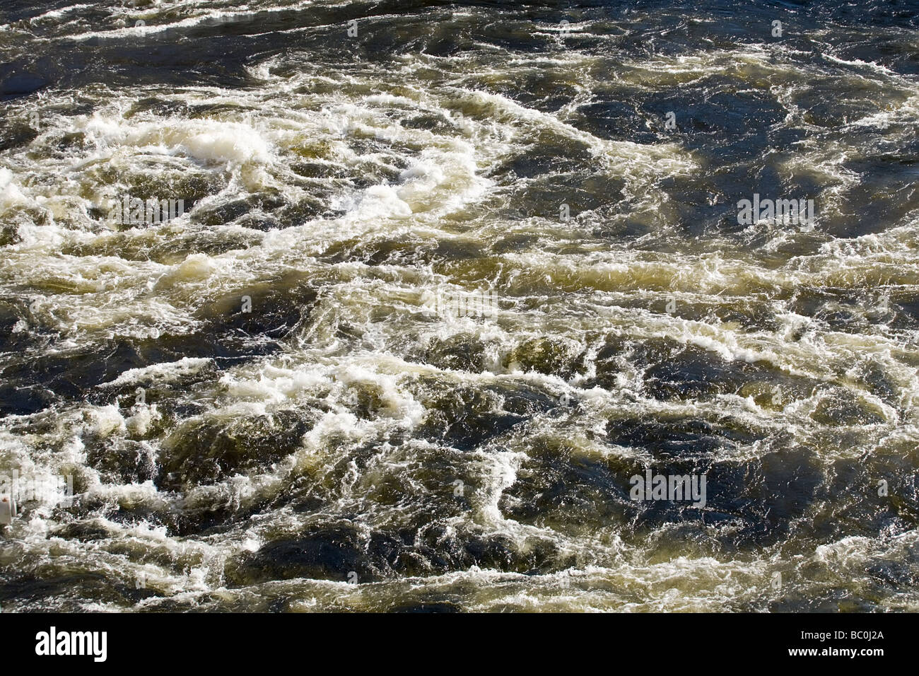 Rapid current of river with splashes and whirlpools Stock Photo - Alamy