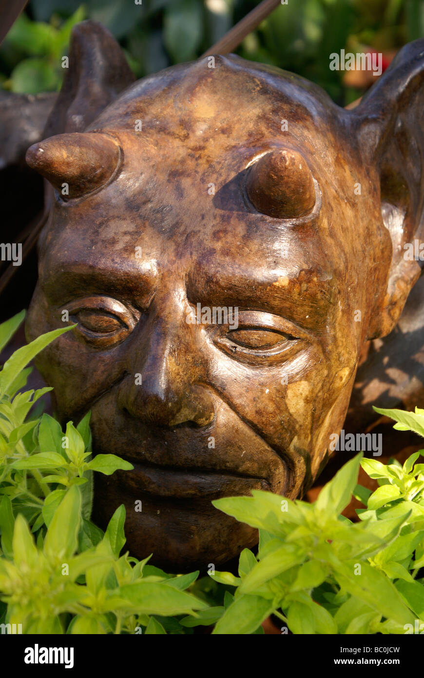 Ceramic garden devil ornament Stock Photo - Alamy