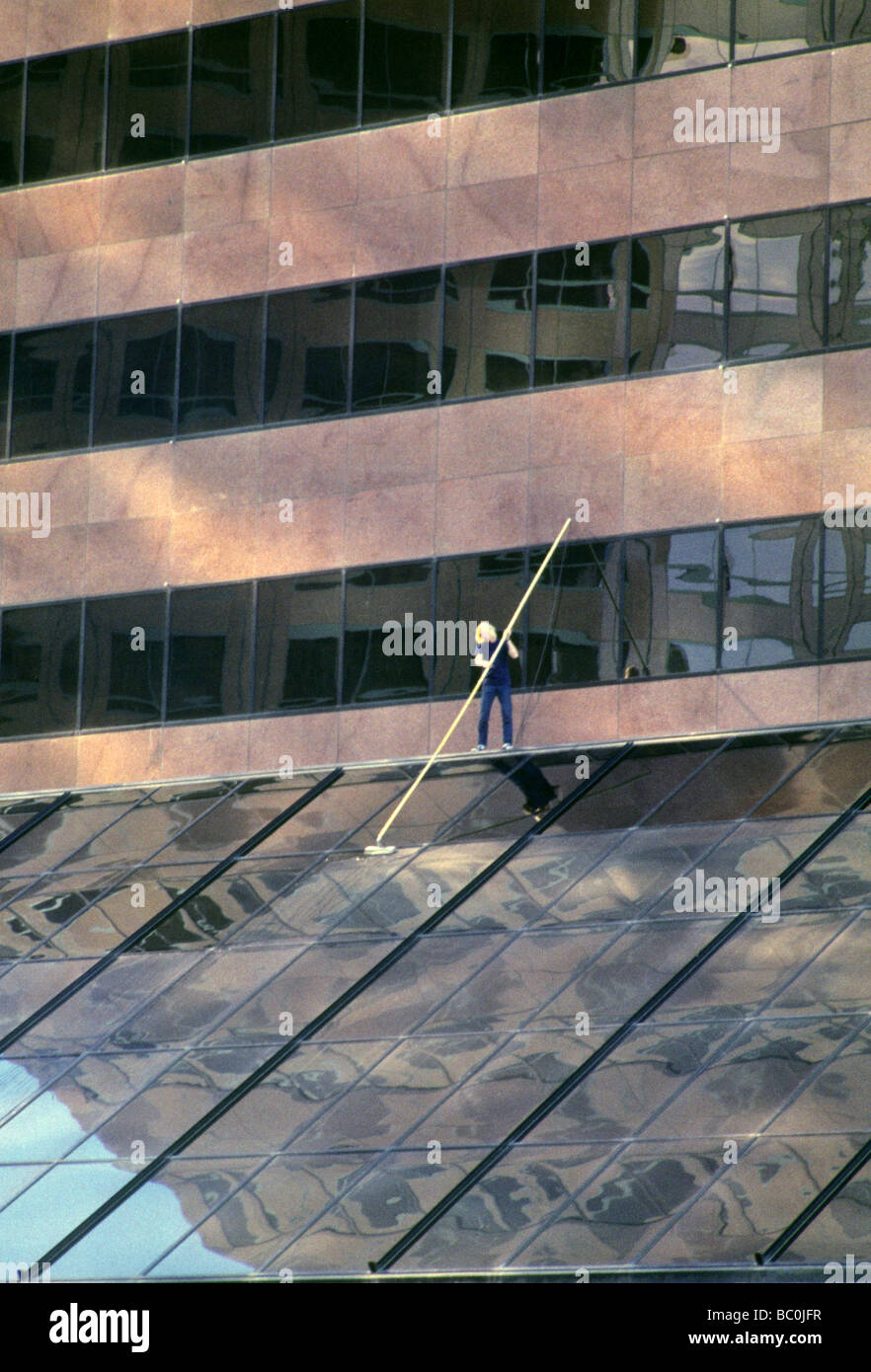 man worker wash window squeegee clean maintain building service safe ...