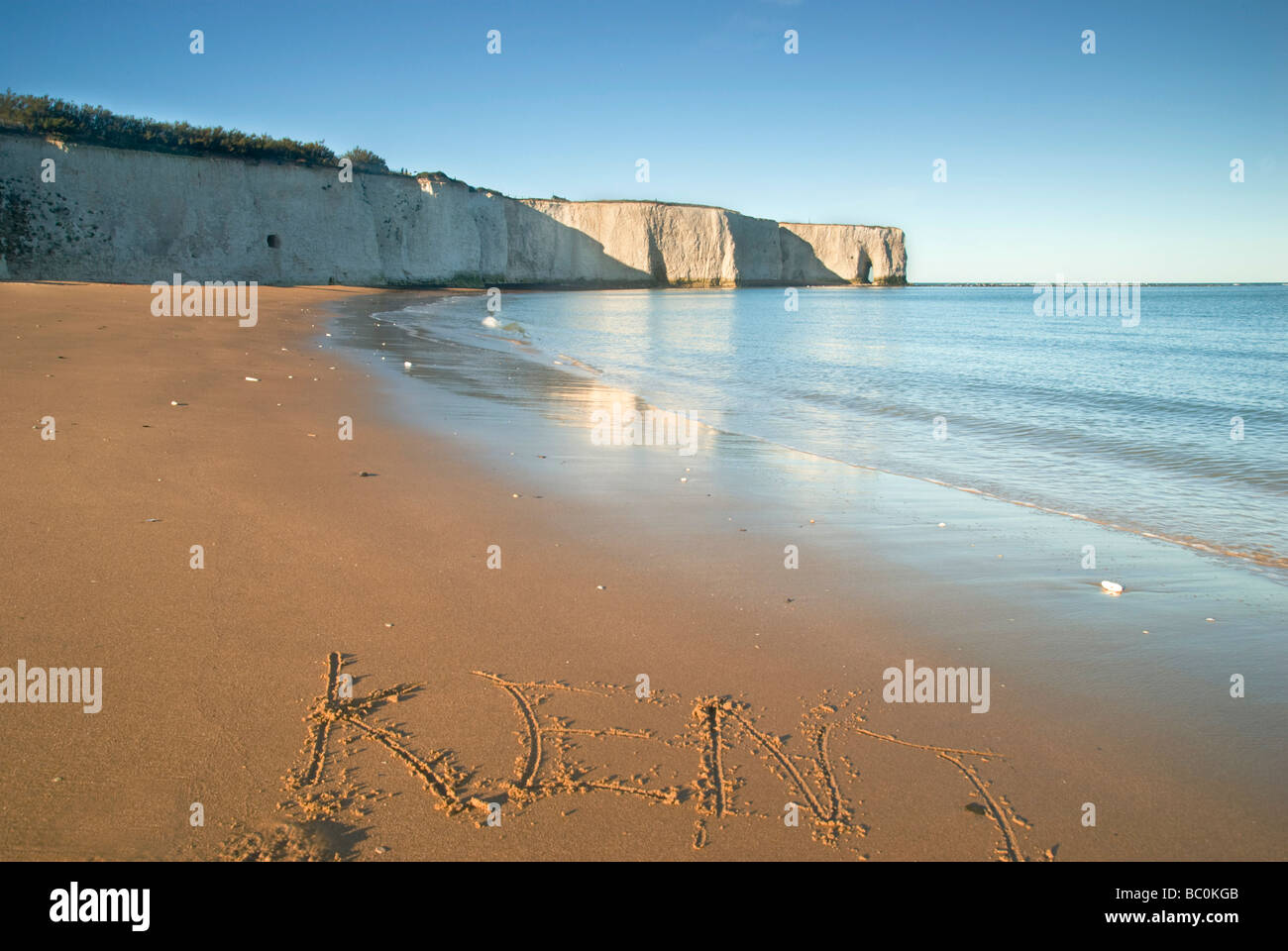 A view along the beach towards a natural hole in the chalk cliff at ...