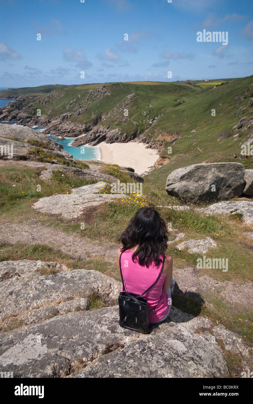 Women sitting on coastal path overlooking Cornish beach Stock Photo - Alamy