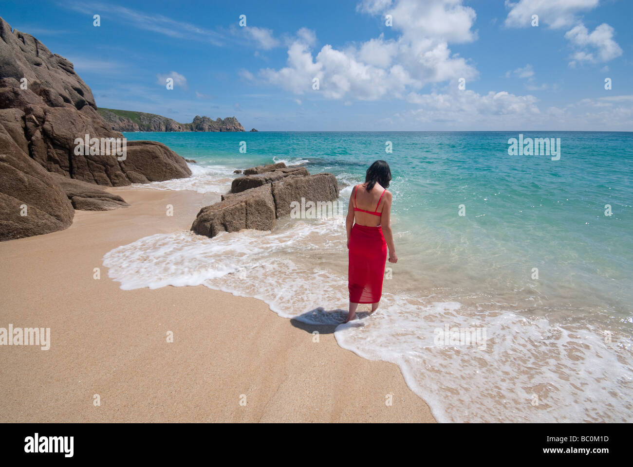 Cornwall, UK: Women testing the water on Porthcurno beach in Cornwall ...