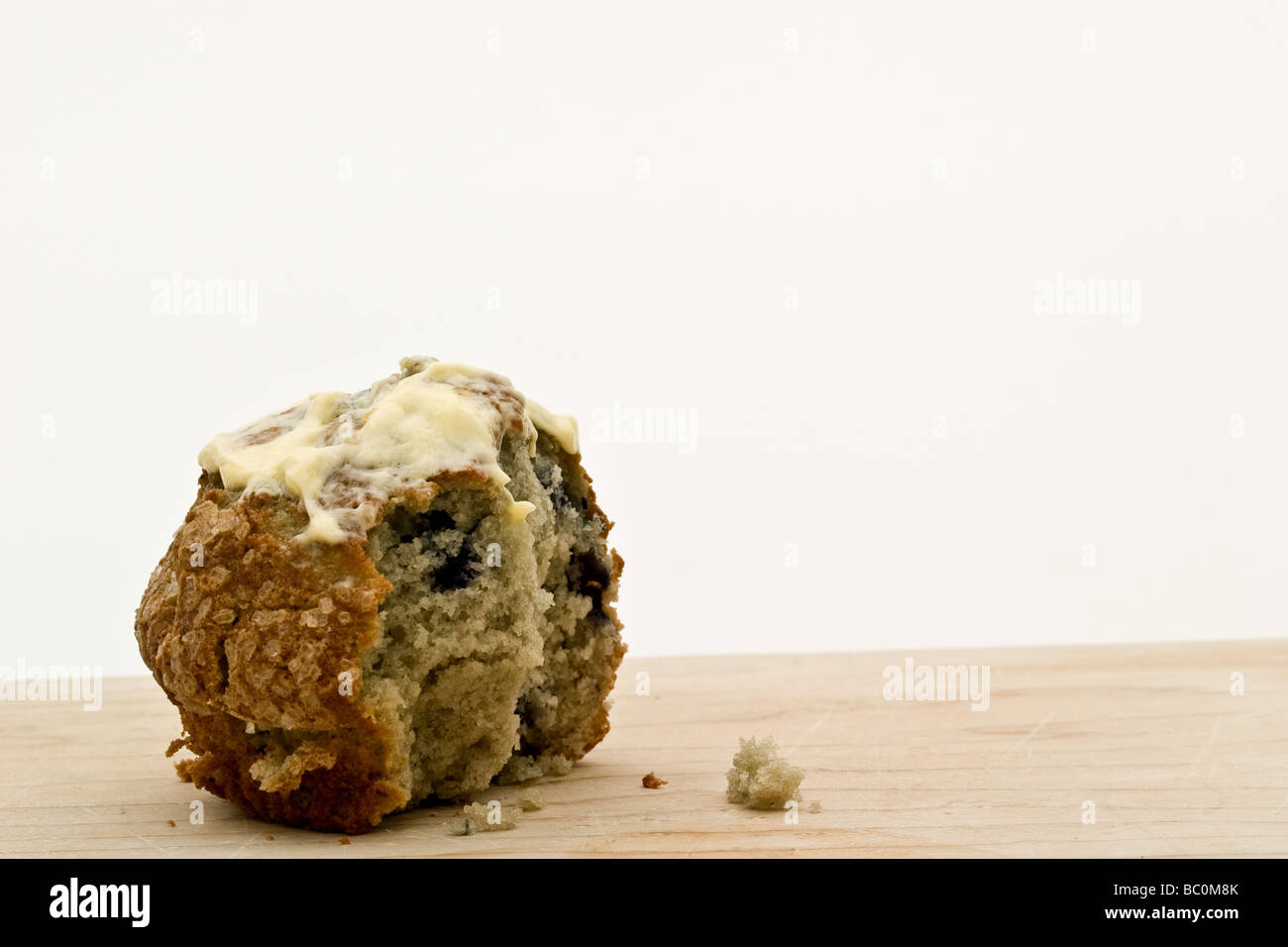 Muffin with butter on top, partially eaten Stock Photo - Alamy