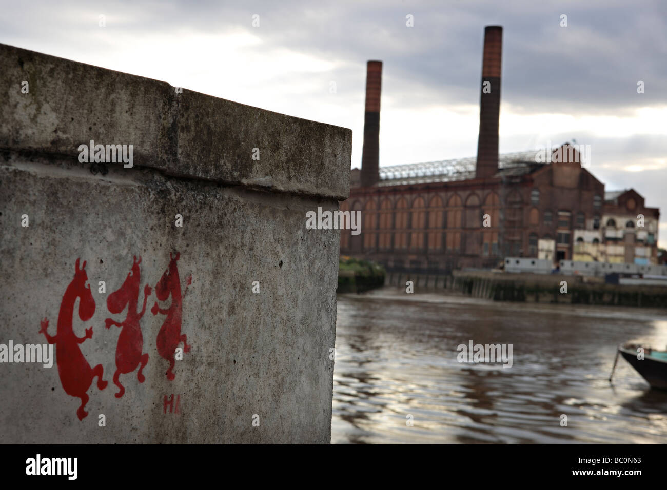 Shot of the River Thames with abandoned factory and three little horses ...