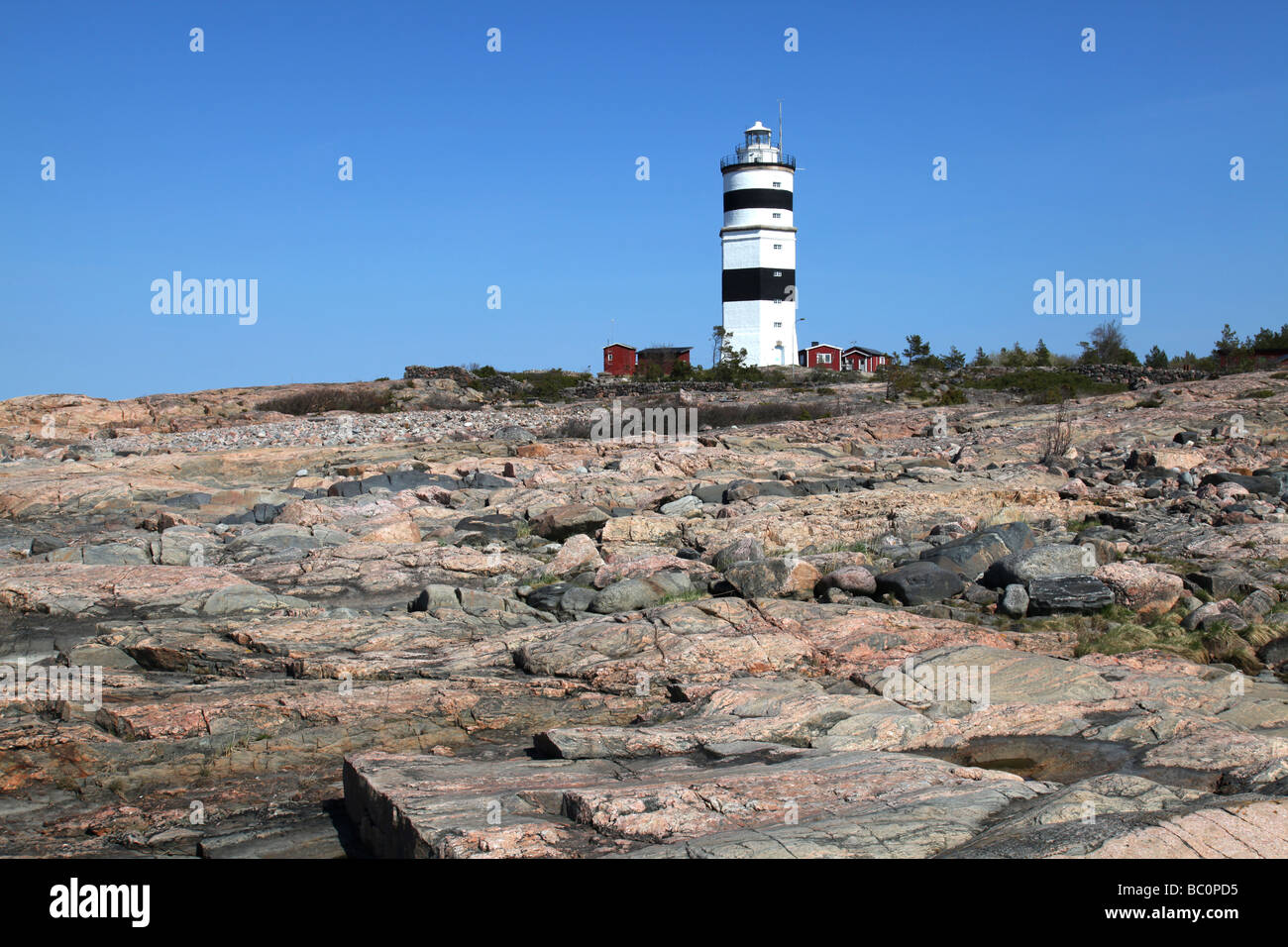 lighthouse on cliff with red cottages Stock Photo - Alamy