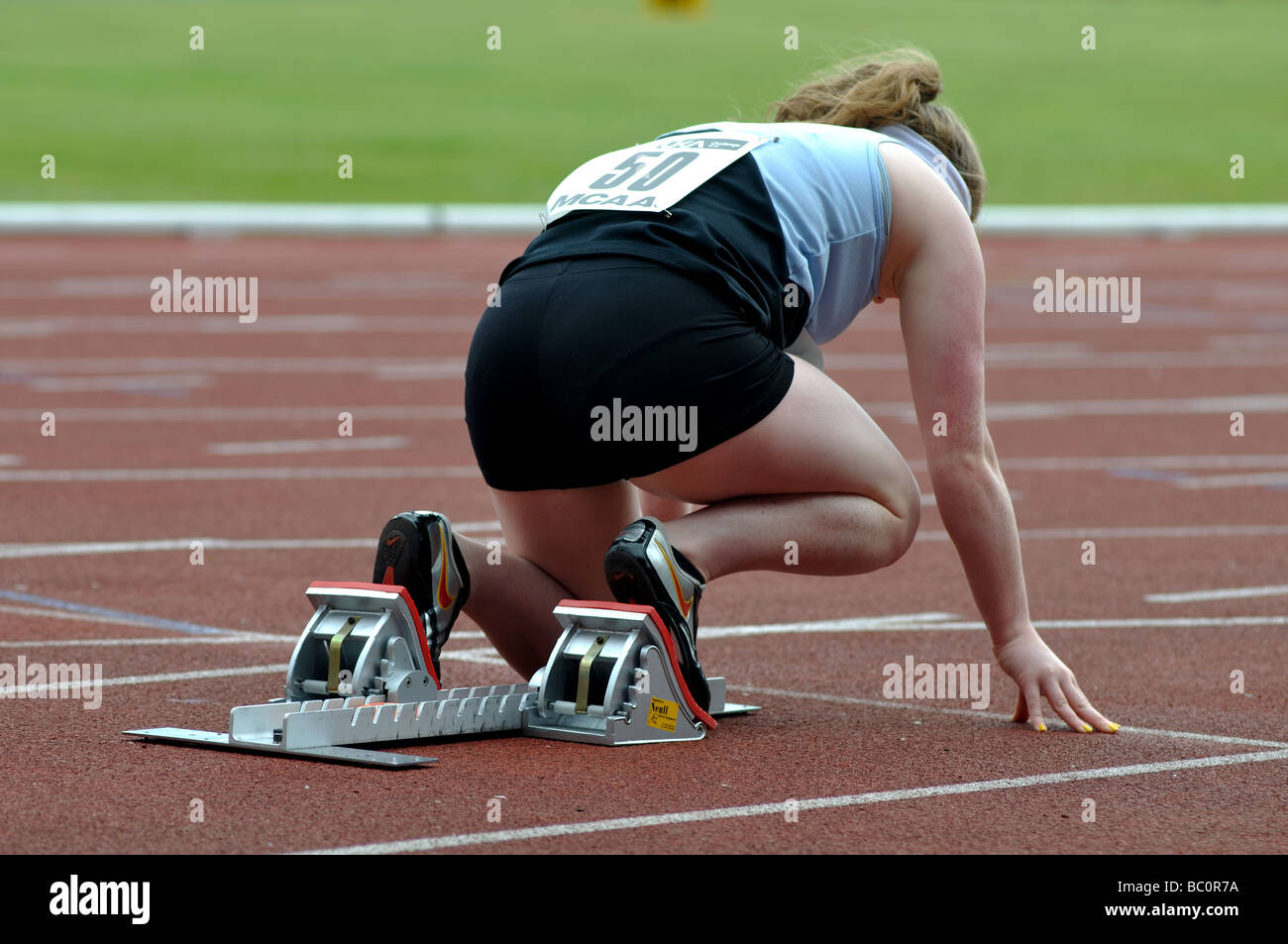 Female athletes in starting blocks hi-res stock photography and images ...