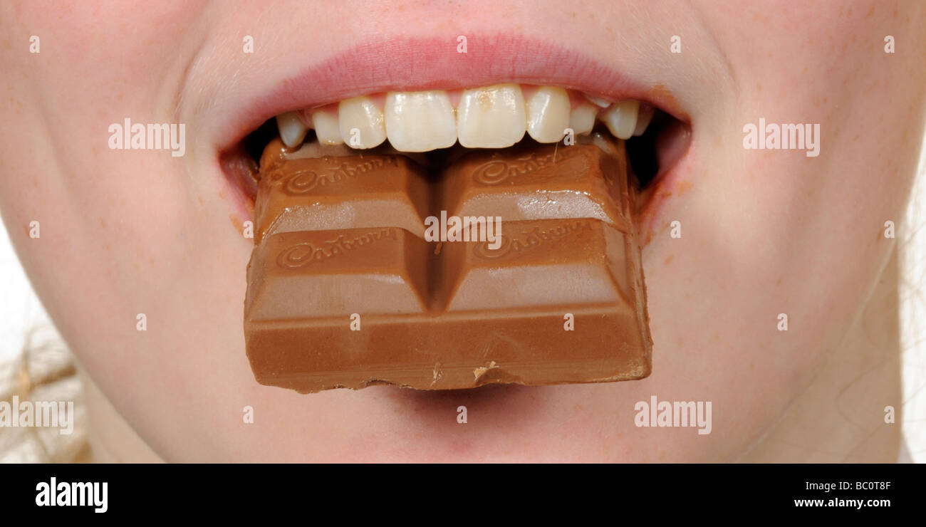 Schoolgirl eating a chocolate bar Stock Photo - Alamy