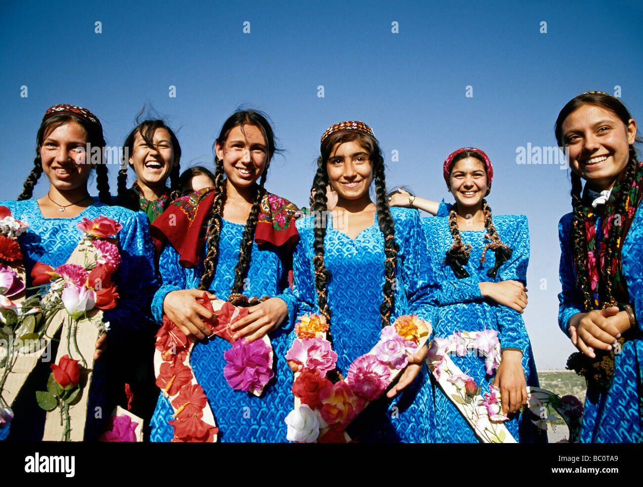 Turkmen school girls in traditional costume for public performance ...