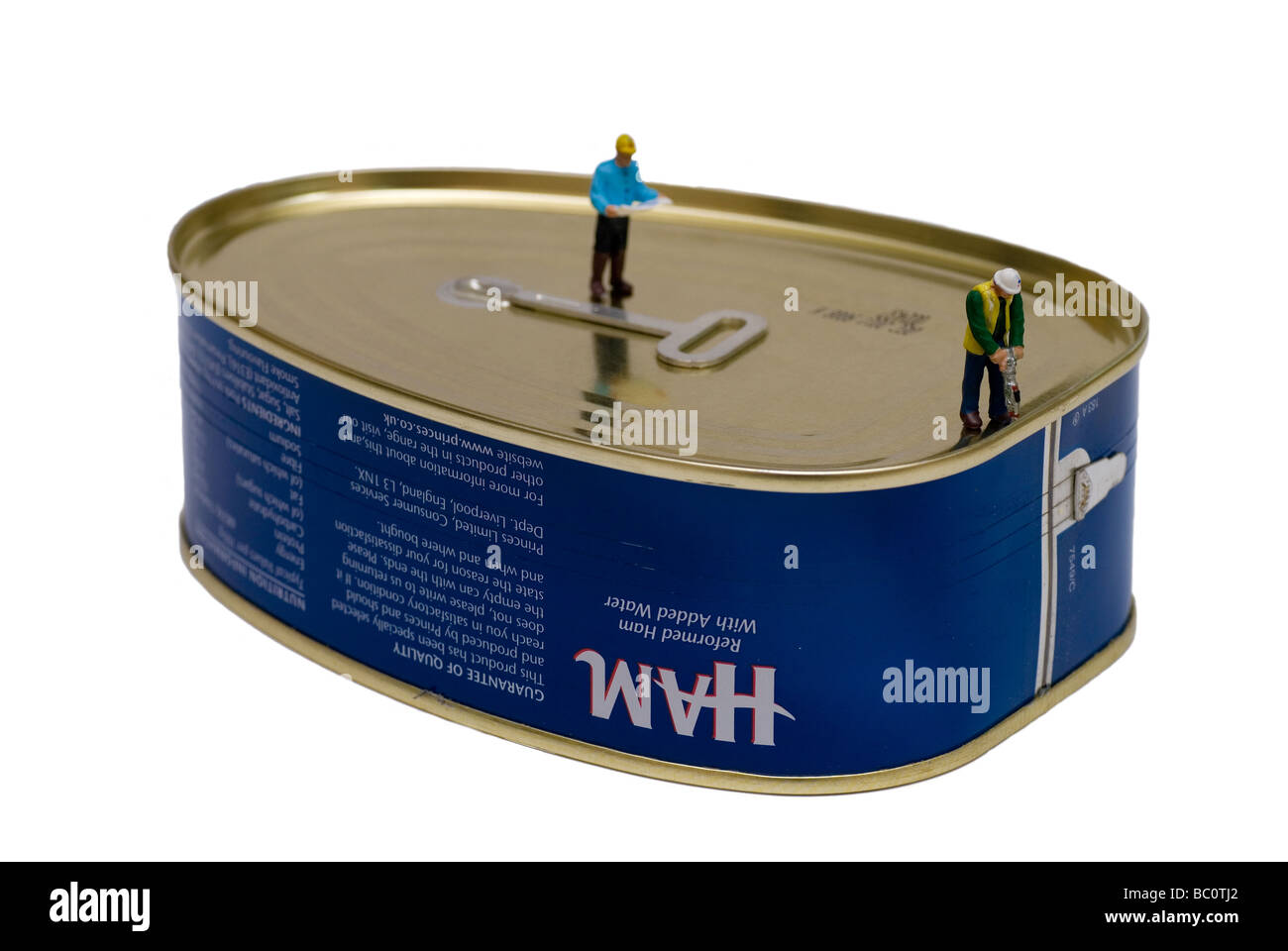 Figurines attempting to open a tin can of Ham with a pnuematic drill ...