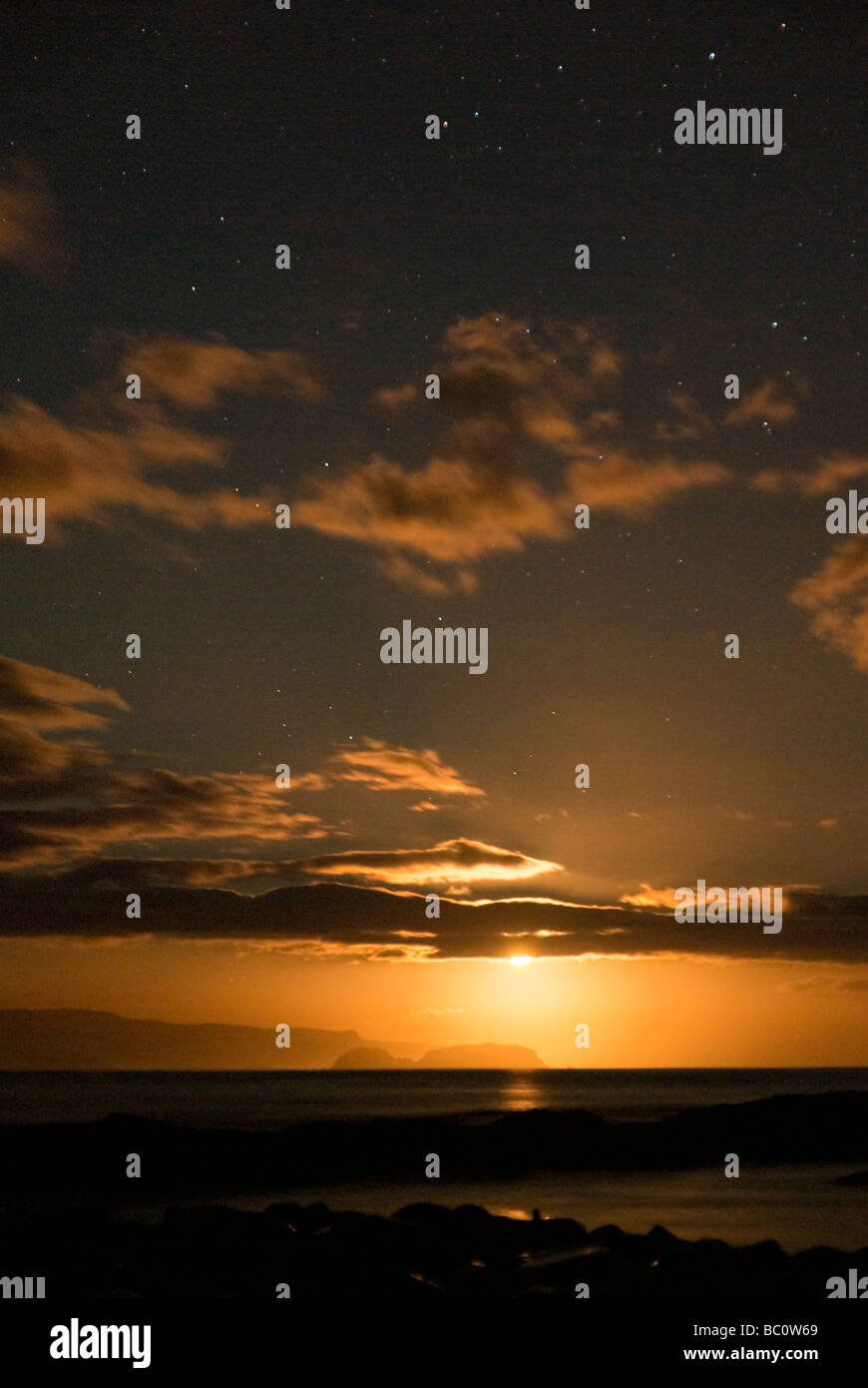 Moonrise over bay Stock Photo - Alamy