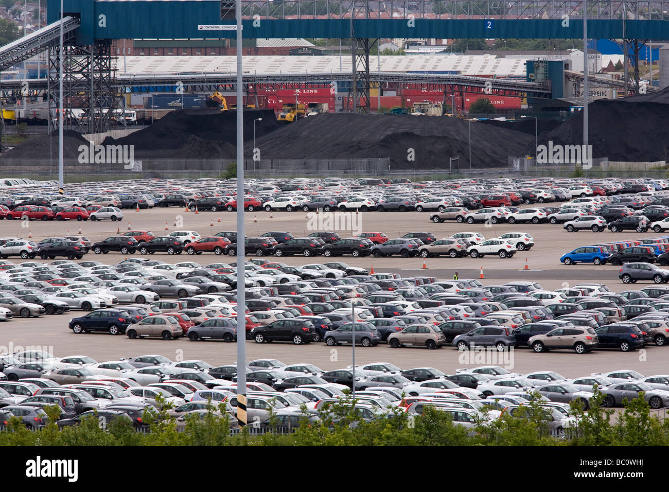 Lines of cars wait to be loaded onto ship for export from the UK, in ...