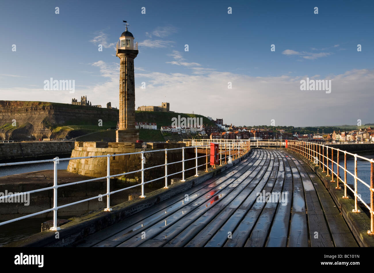 The lighthouse on Whitby Pier with St. Hilda's Abbey and St. Mary's ...