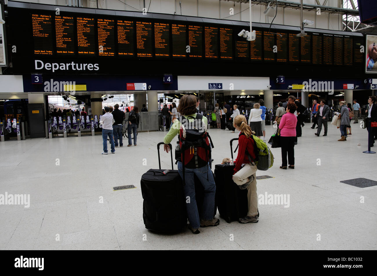 Waterloo Station London travellers and the departures information board ...