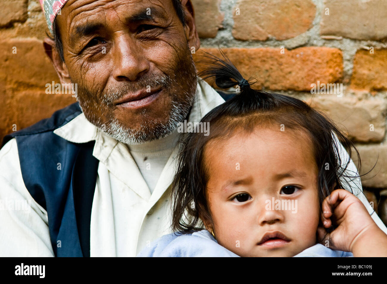 Portrait of a Nepali man with his child Stock Photo - Alamy