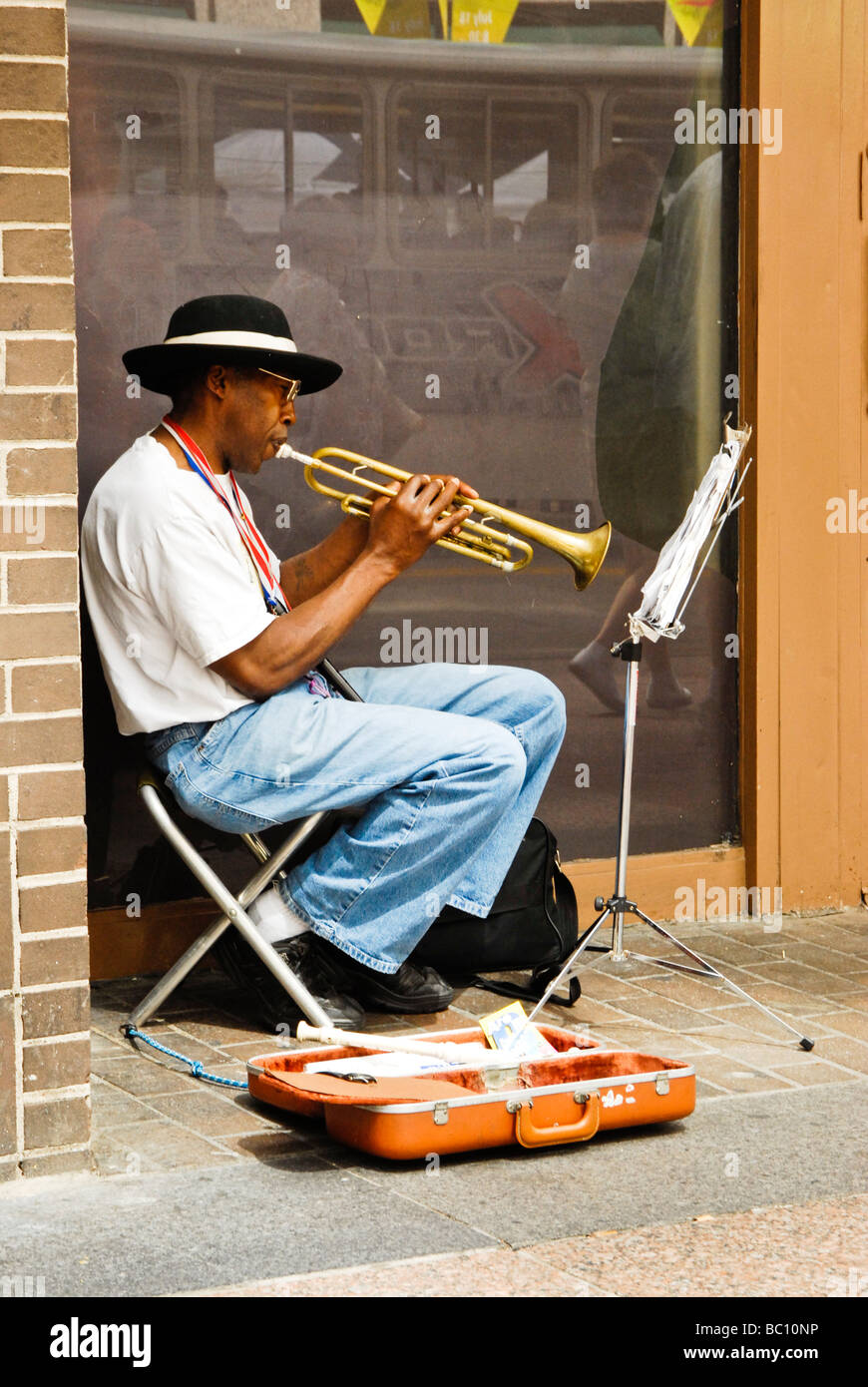 a street performer playing a trumpet in an urban setting Stock Photo ...