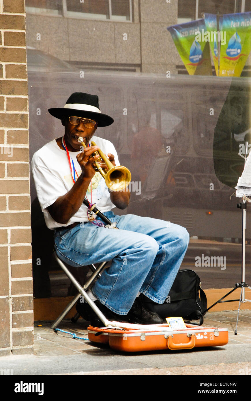 a street performer playing a trumpet in an urban setting Stock Photo ...