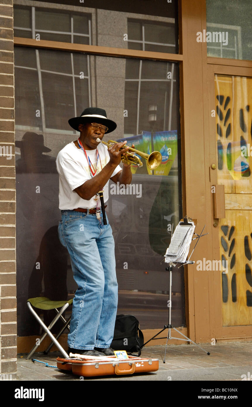 a street performer playing a trumpet in an urban setting Stock Photo ...