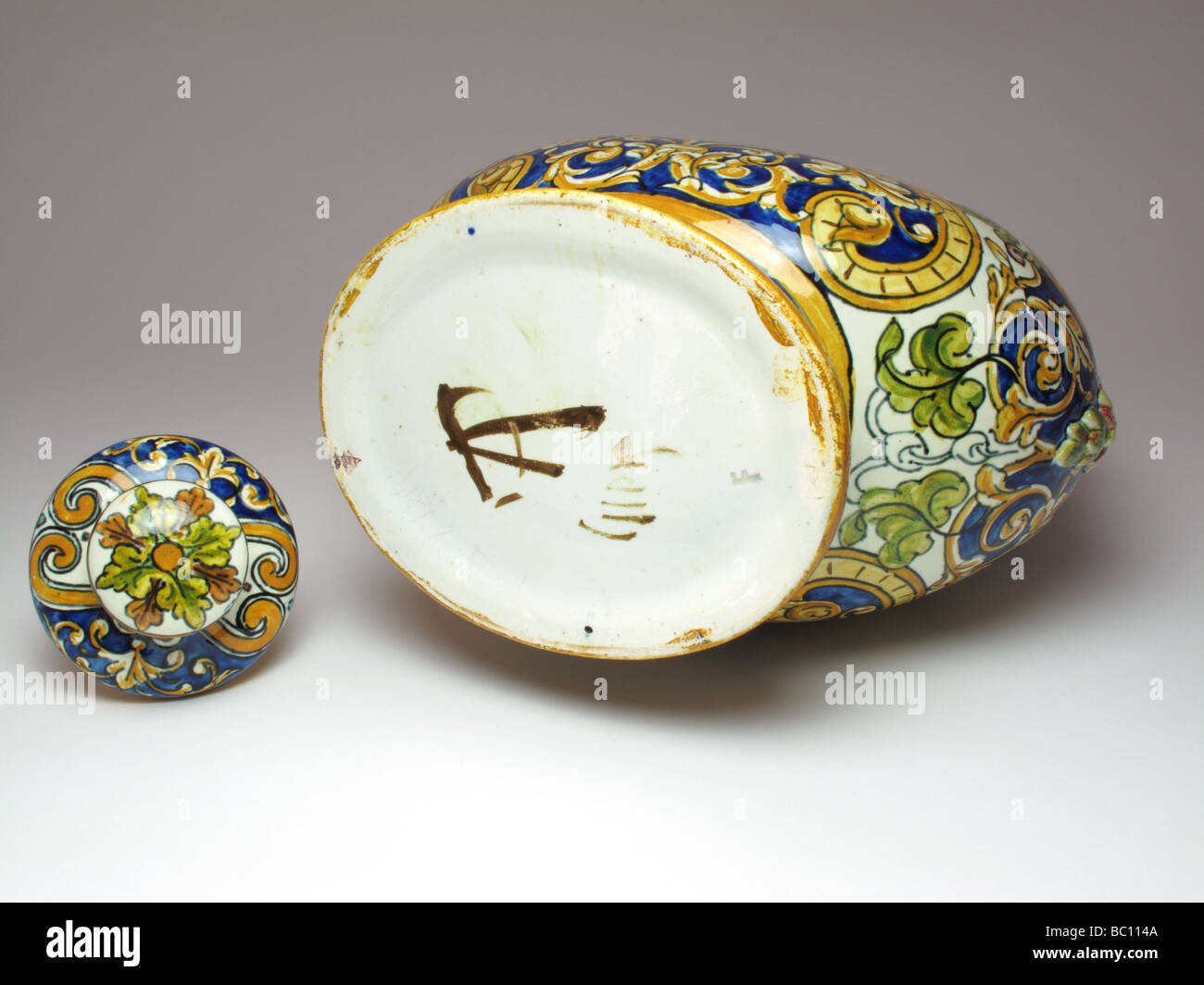 Gien flask and cover with hand painted decoration with Bacchus masks to ...