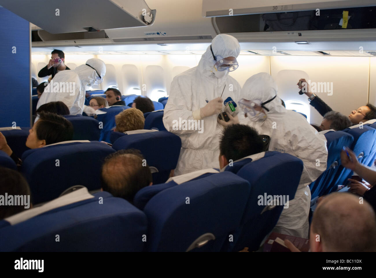 Medical workers aboard the plane from Amsterdam check passengers for ...
