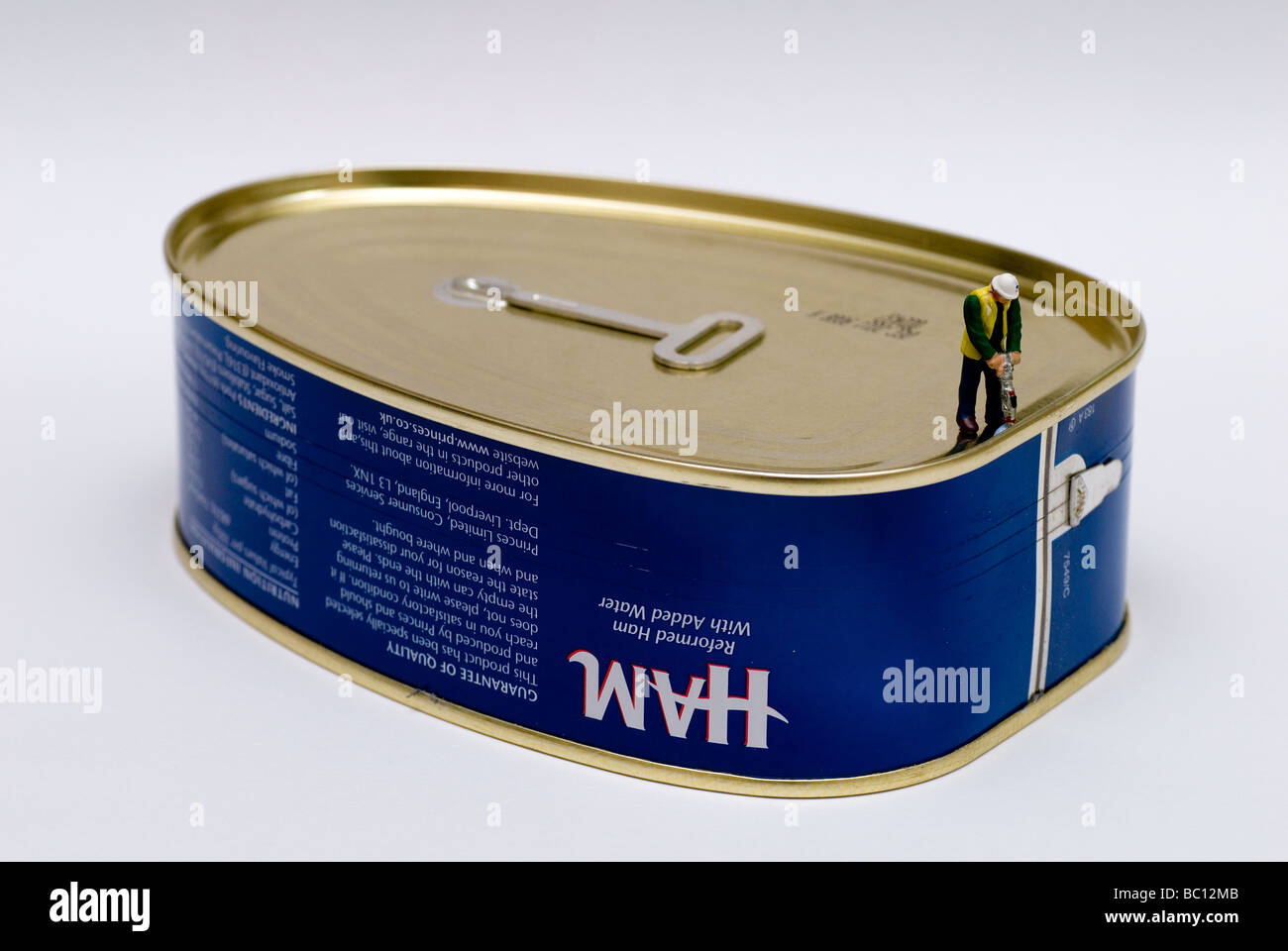 Figurines attempting to open a tin can of Ham with a pnuematic drill ...