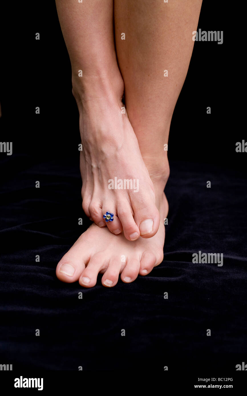 Woman's bare feet crossed Stock Photo - Alamy