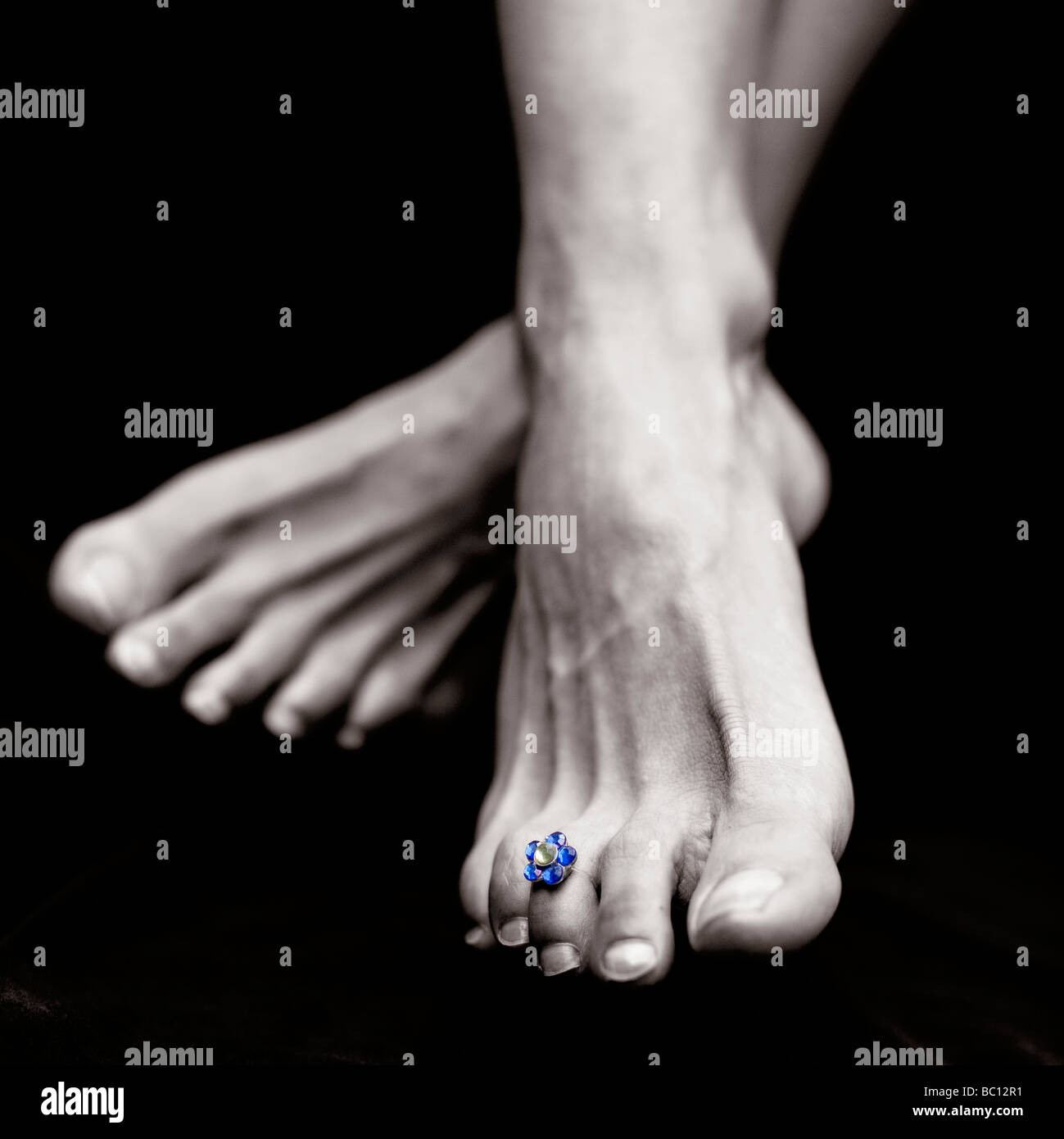 Woman's crossed bare feet Stock Photo - Alamy