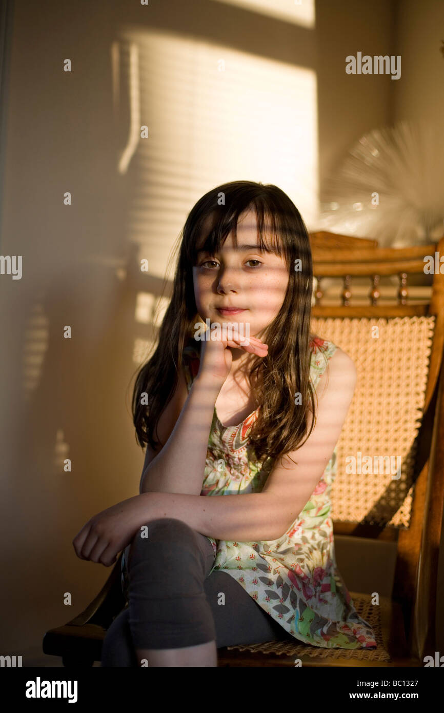 Young girl sitting in rocking chair Stock Photo - Alamy