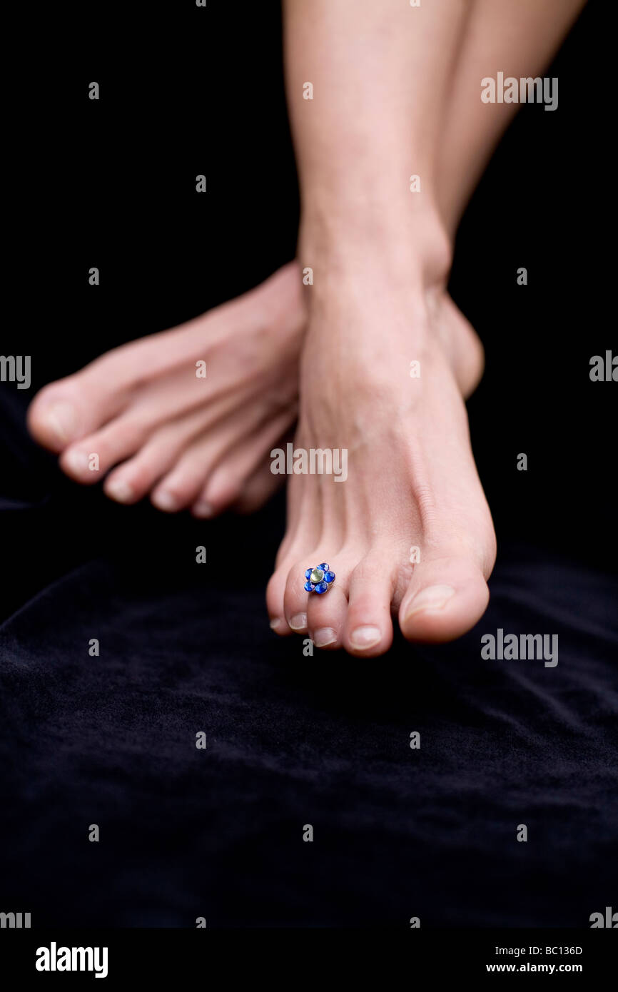 Woman's crossed bare feet Stock Photo - Alamy