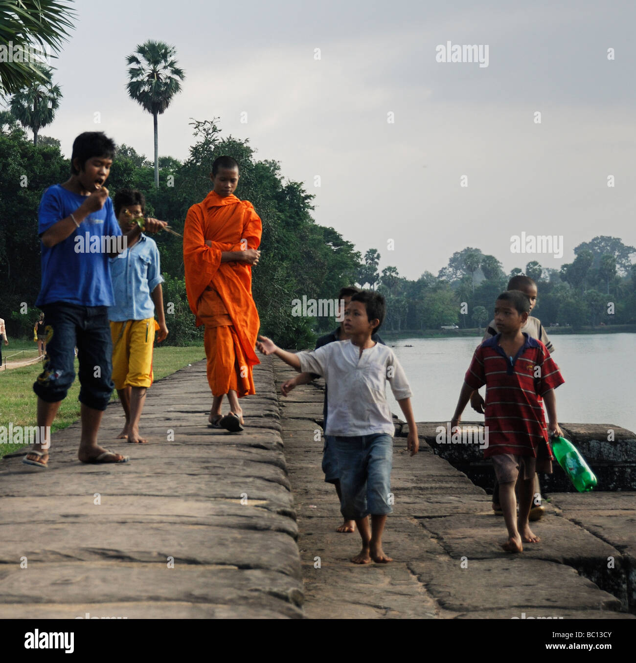 Buddhist monk with local children at Angkor Wat in Cambodia Stock Photo ...