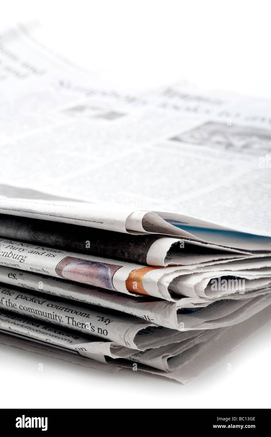 A vertical image of a bundle of folded newspapers Stock Photo - Alamy