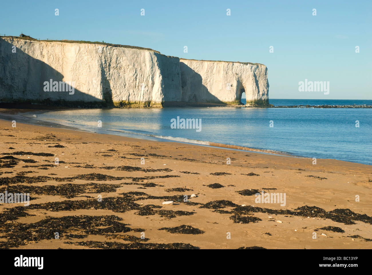 A view along the beach towards a natural hole in the chalk cliff at ...