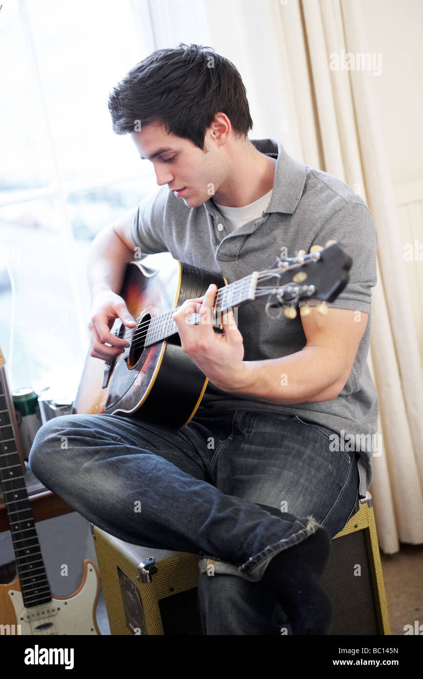 Young man playing the guitar Stock Photo - Alamy