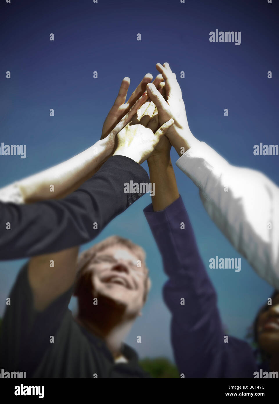 Group Of People Giving High Five To Each Other Stock Photo - Alamy