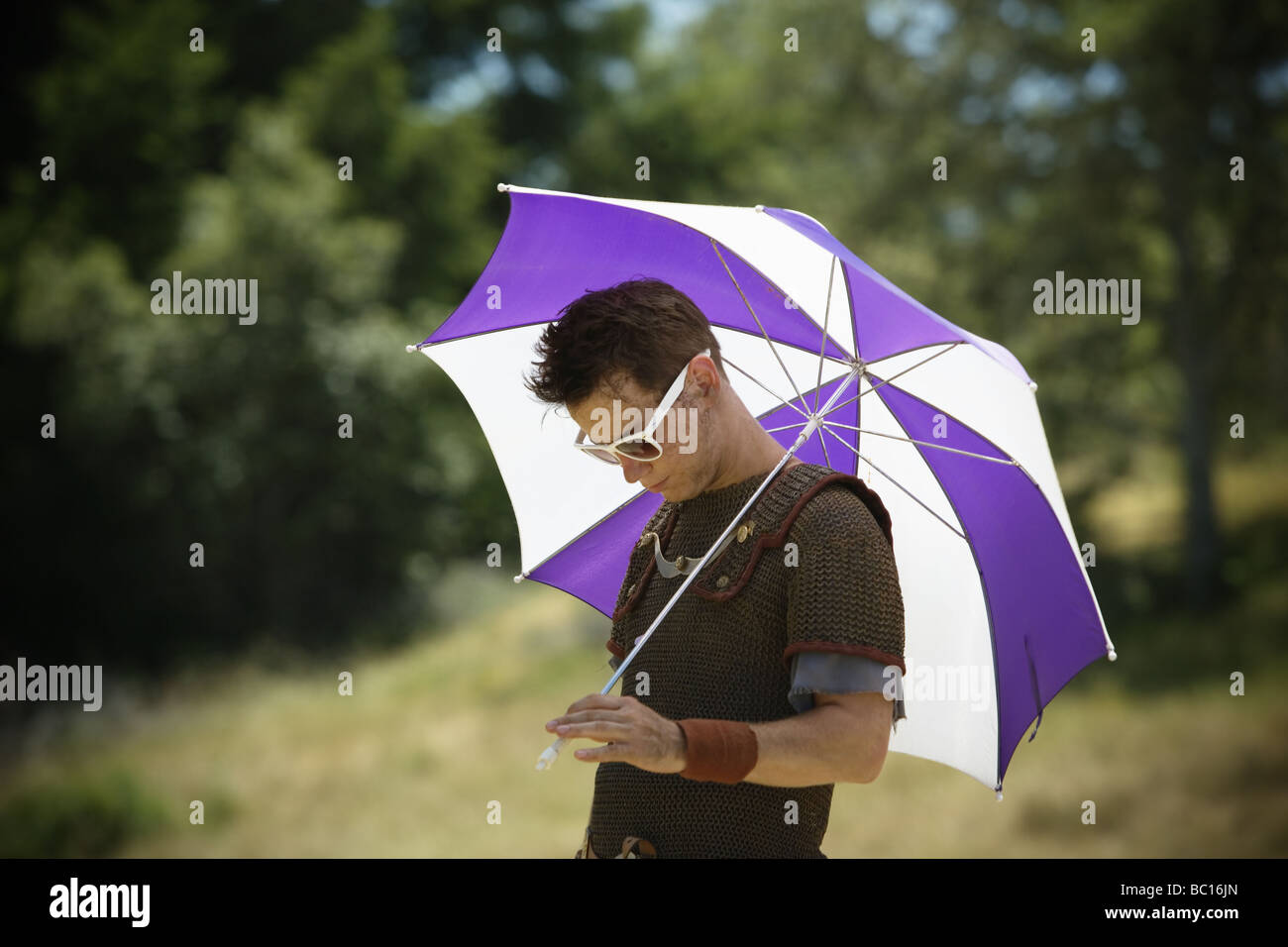 A man holding a colorful umbrella Stock Photo - Alamy